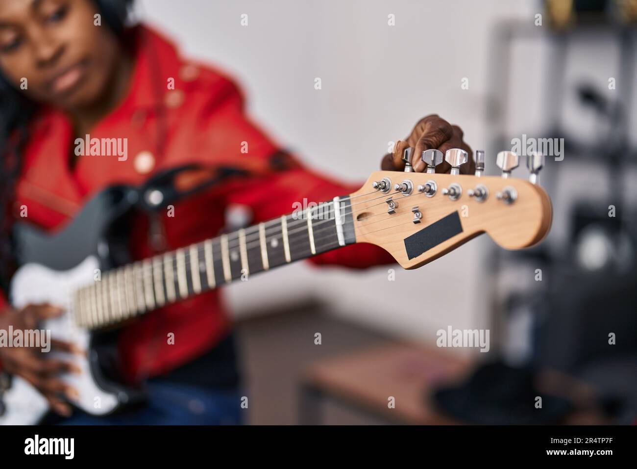 African american woman musician playing guitar at music studio Stock ...