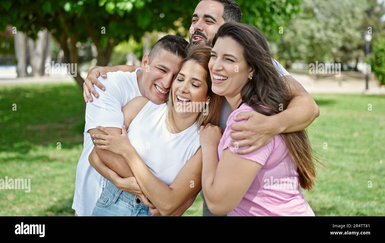 Group of people hugging each other smiling at park Stock Photo - Alamy
