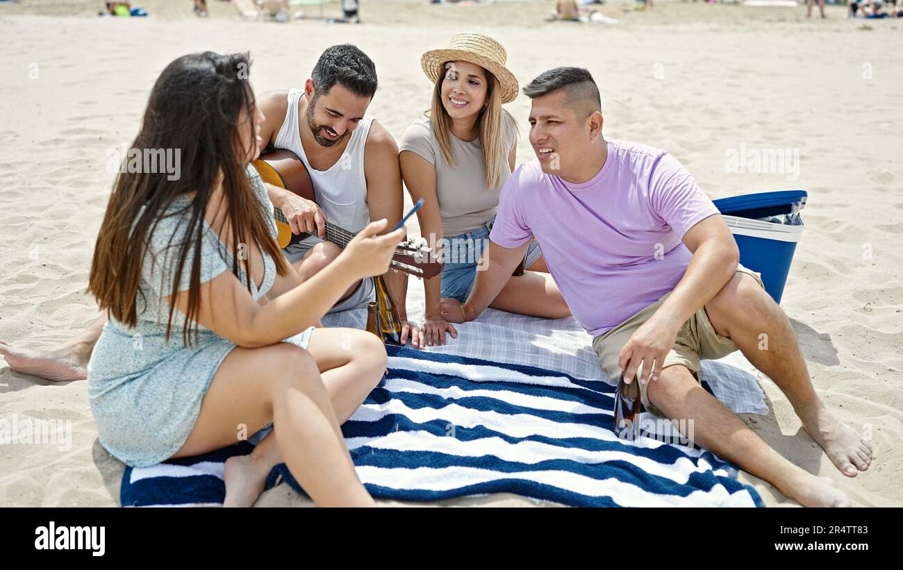 Group of people using smartphone having party at beach Stock Photo - Alamy