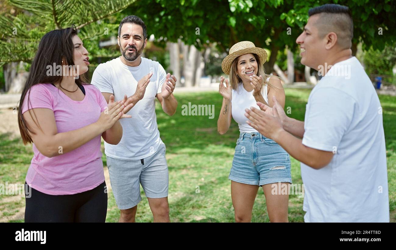 Group of people smiling confident clapping applause at park Stock Photo ...