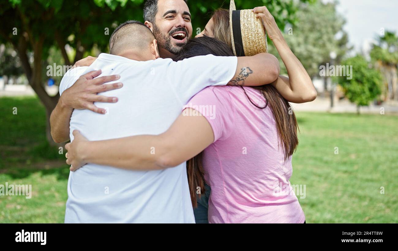 Group of people hugging each other smiling at park Stock Photo - Alamy