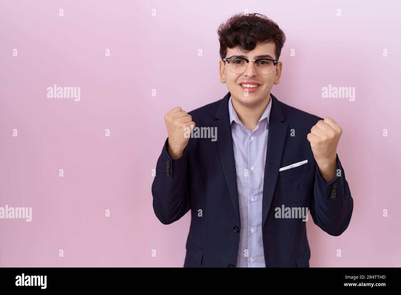 Young non binary man with beard wearing suit and tie celebrating ...
