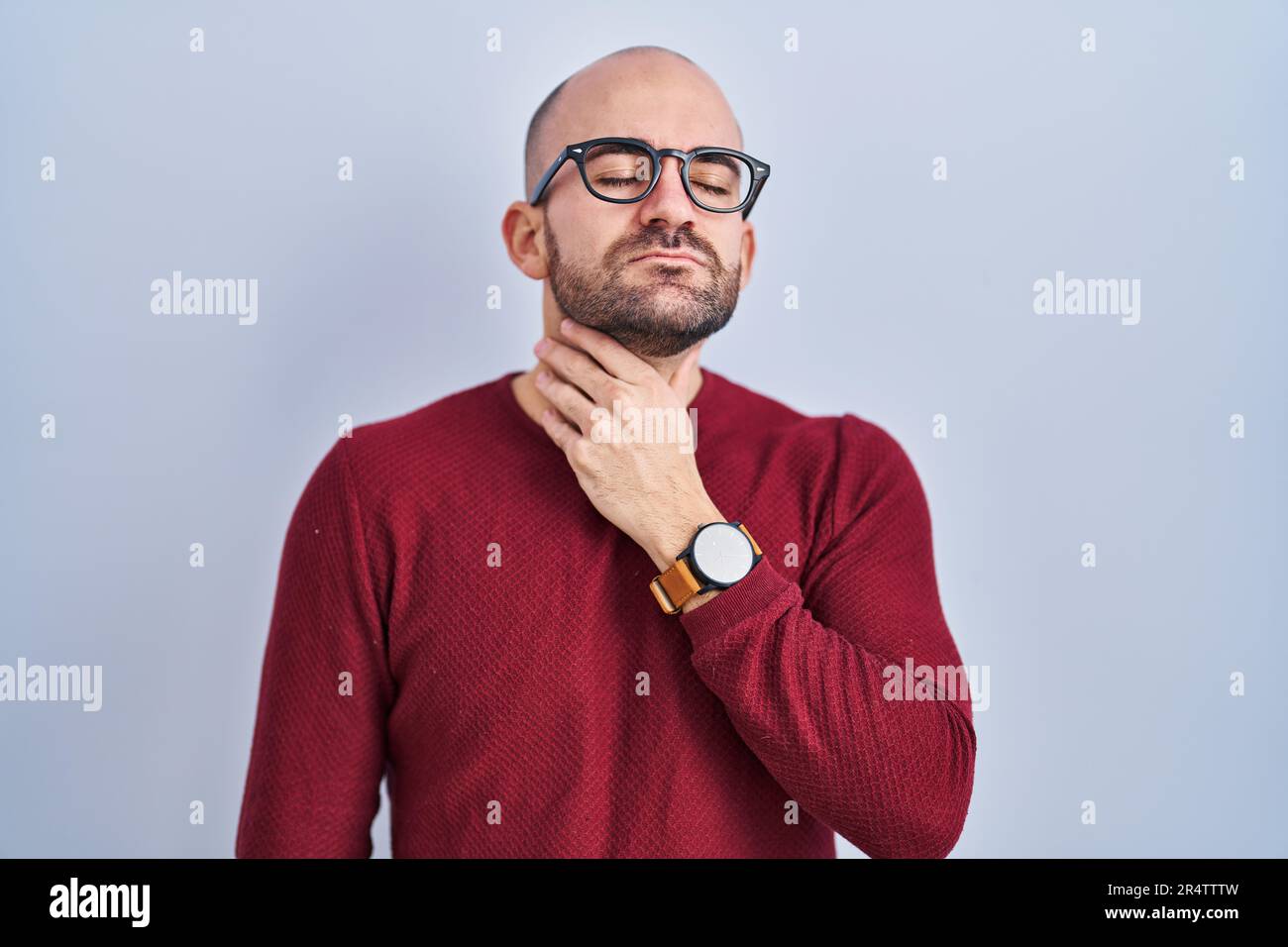 Young bald man with beard standing over white background wearing ...