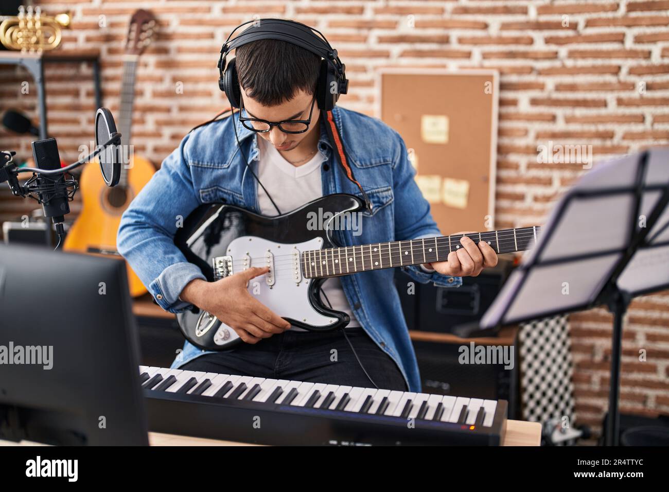 Young man artist playing electrical guitar at music studio Stock Photo ...
