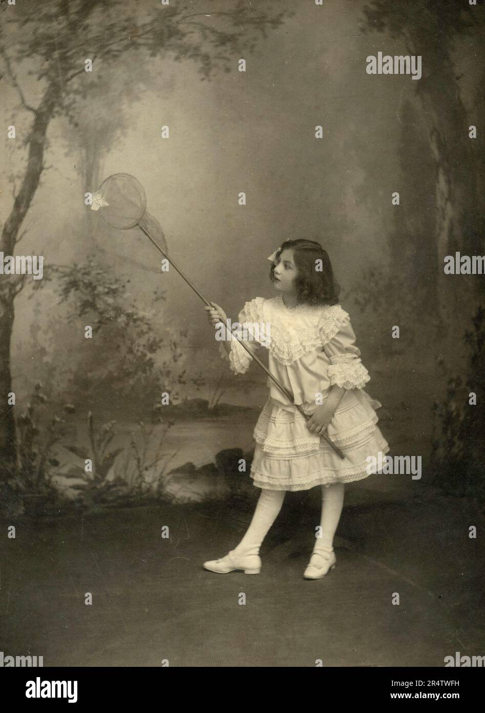 Studio portrait of a young girl butterfly hunting, Italy 1900s Stock ...
