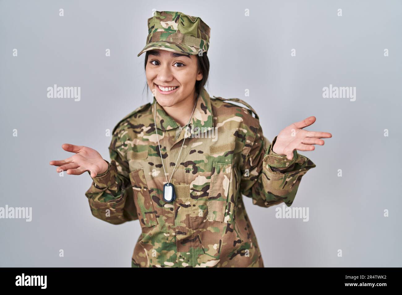 Young south asian woman wearing camouflage army uniform smiling ...