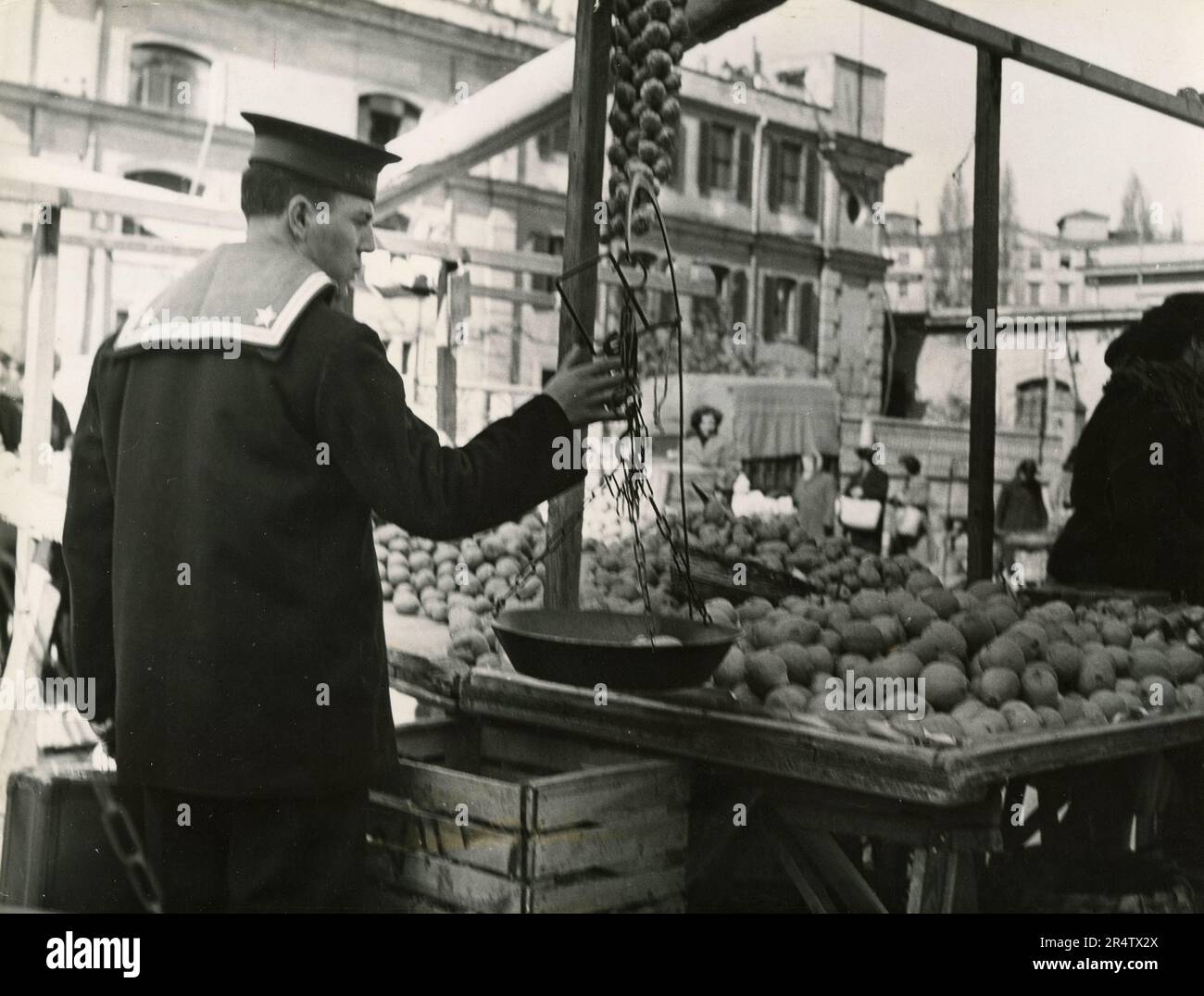 Italian Navy sailor buying fruits from a stall in the market, Italy ...