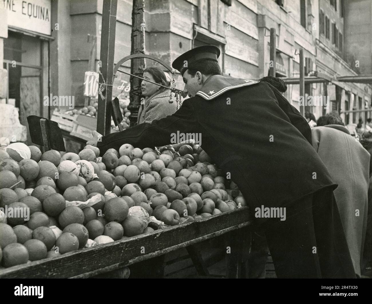 Italian Navy sailor buying fruits from a stall in the market, Italy ...