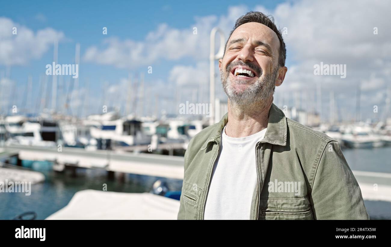Middle age man smiling confident standing at port Stock Photo - Alamy