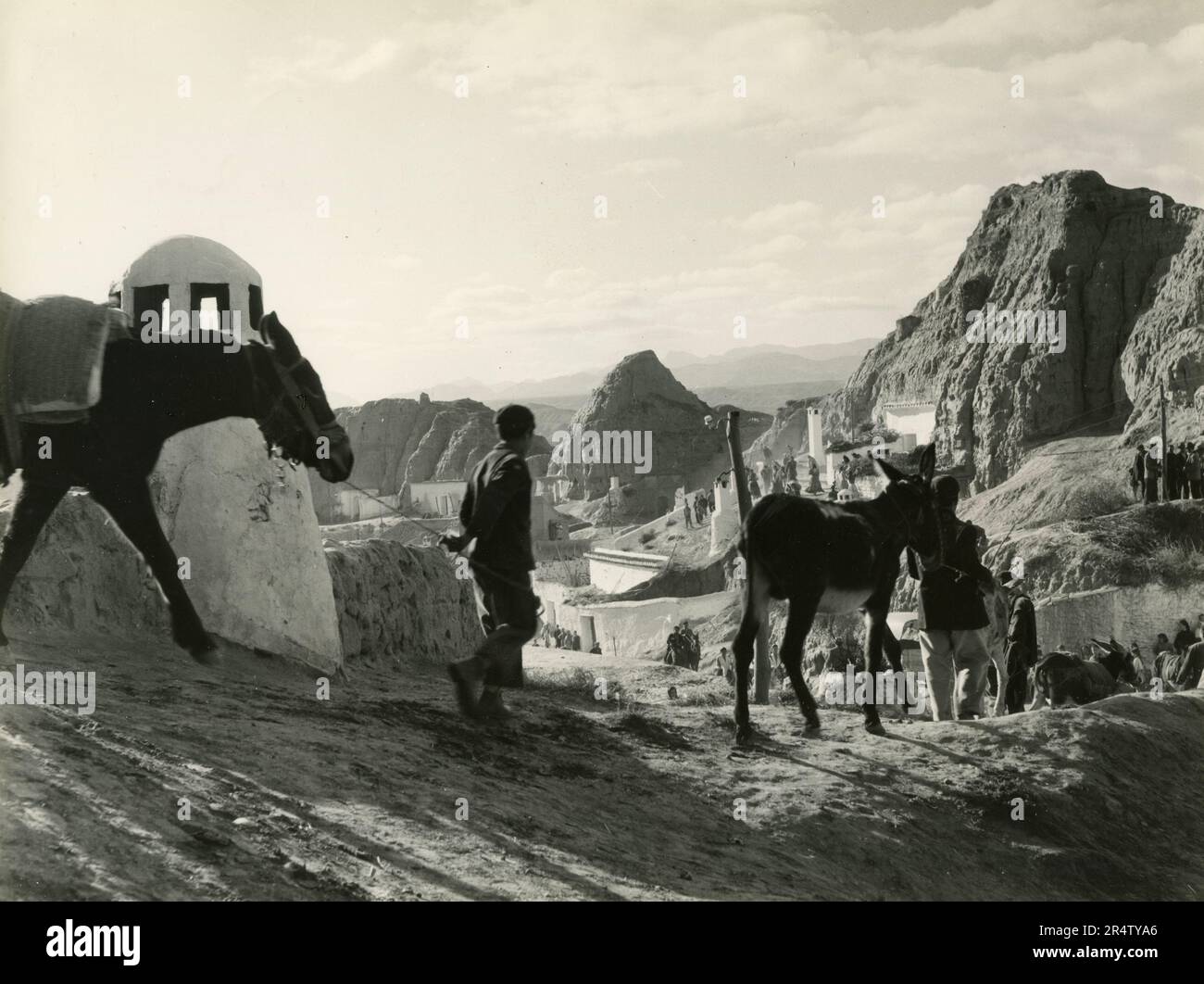 People and donkeys on the small road to the village, Spain 1970s Stock ...
