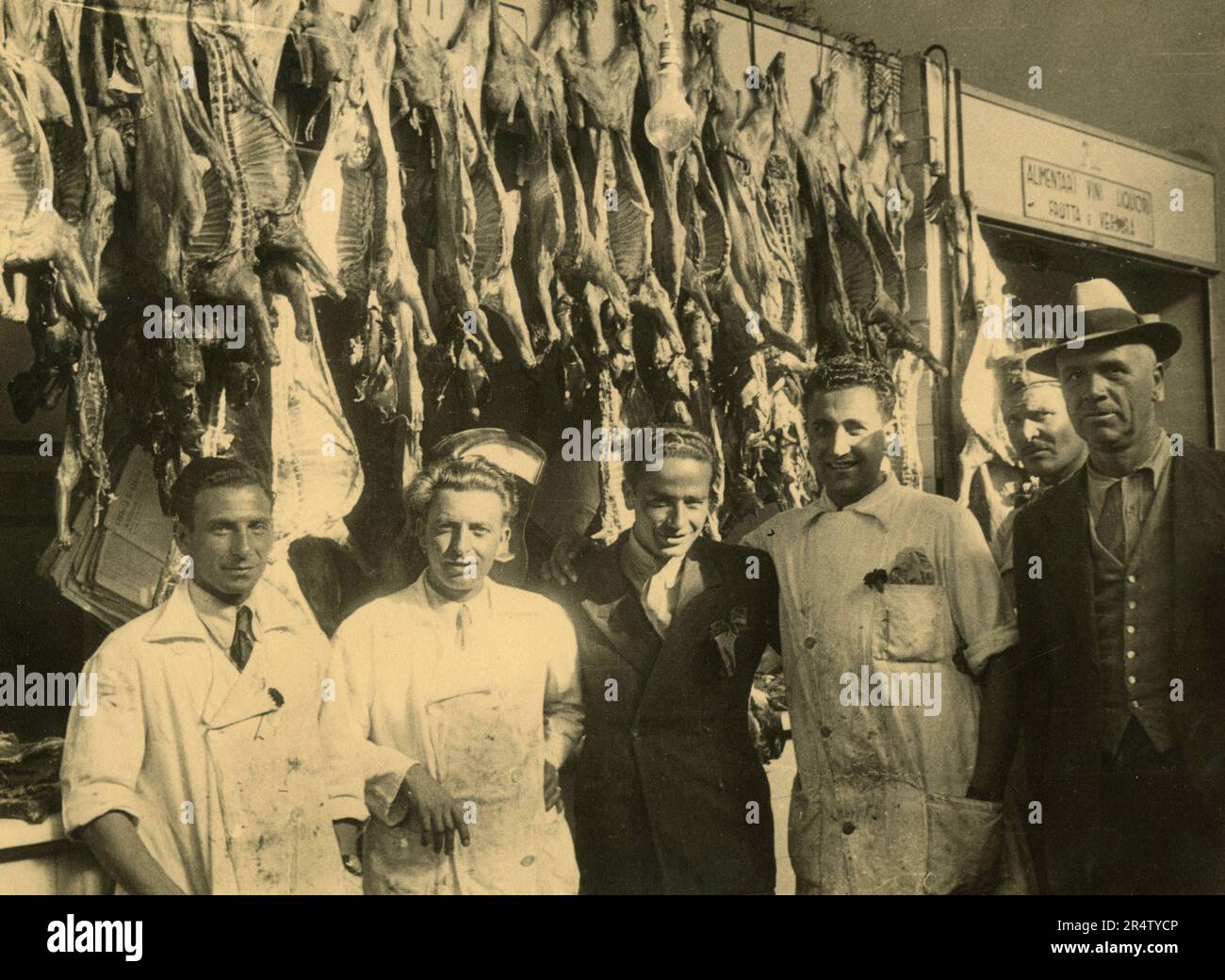 Photo with the family and the beef quarters hanging inside the butcher ...
