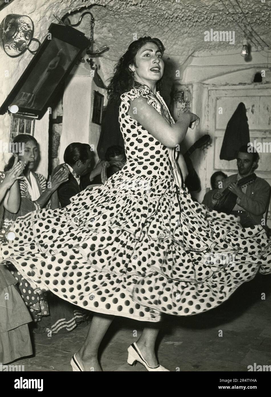 Young woman wearing traditional Spanish dress dancing Flamenco, Spain ...