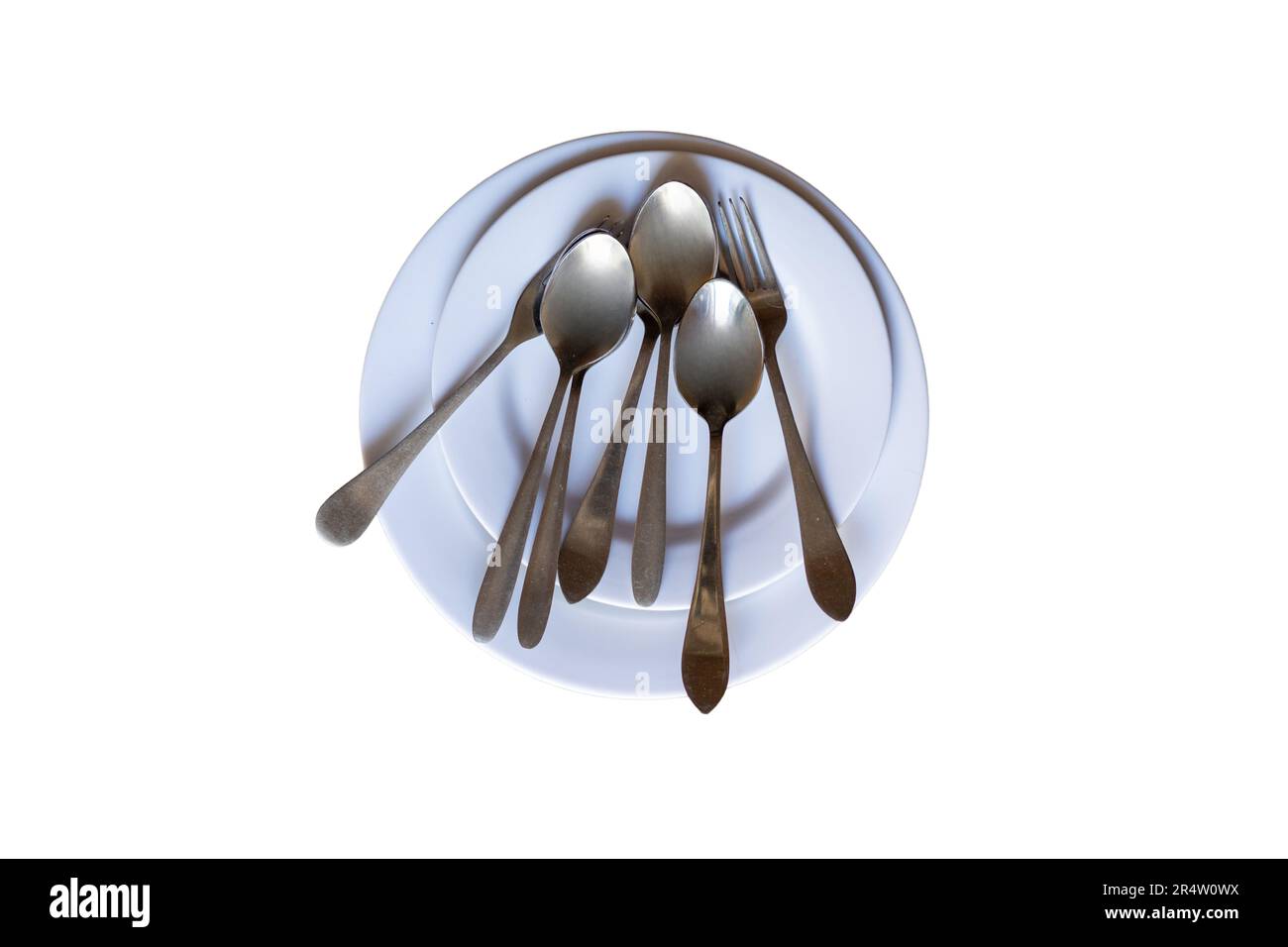 White plates with spoon and fork table set on white isolated background ...