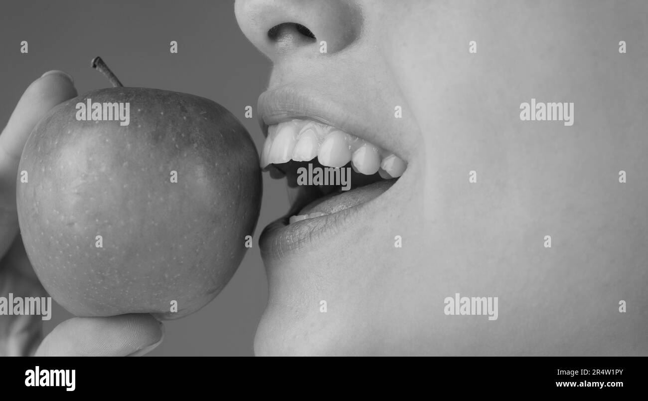 Beautiful young woman eating a apple. Healthy white teeth close up with ...