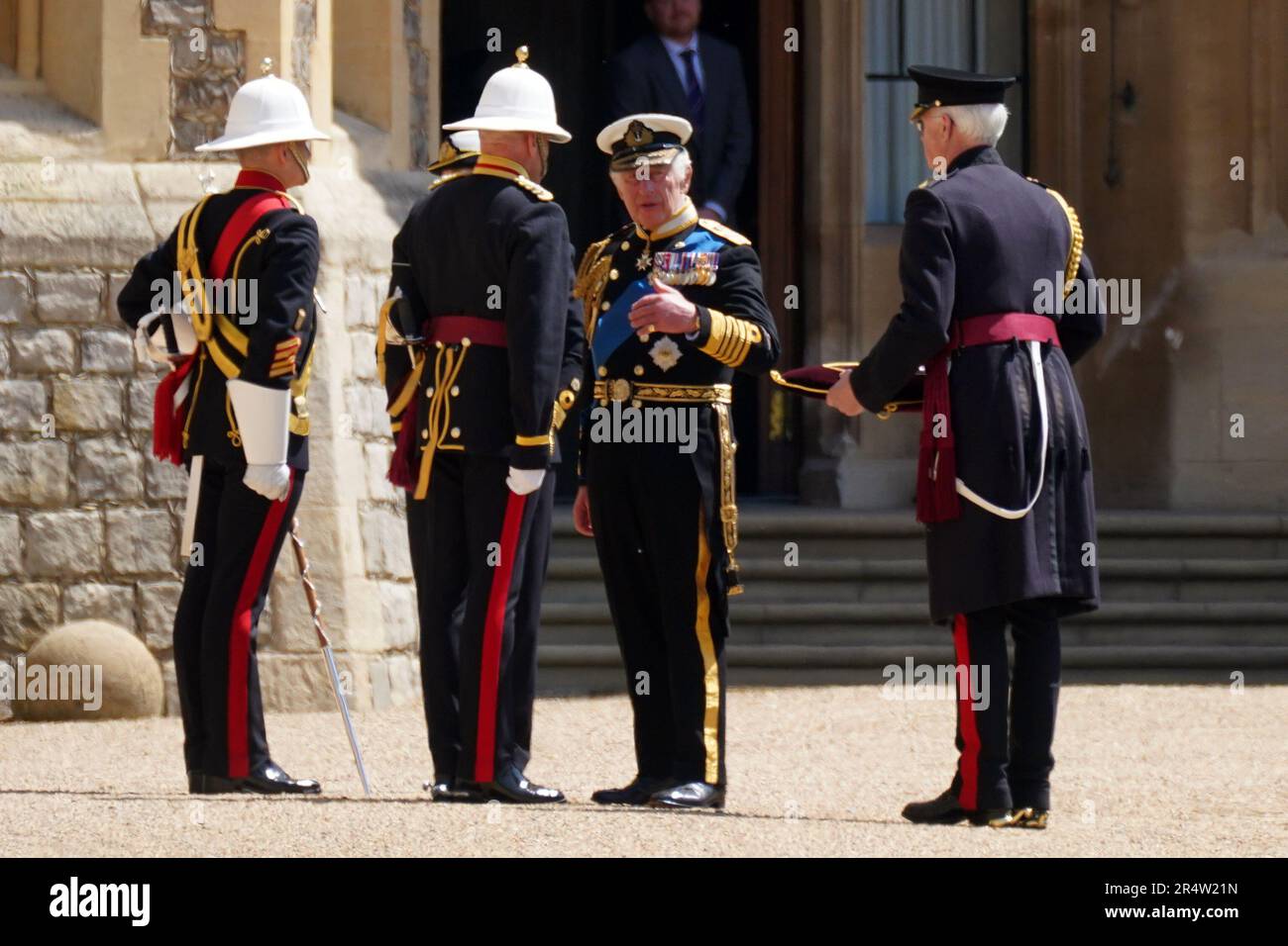 King Charles III (centre) presents members of the Royal Navy with the Royal Victorian Order, in ...