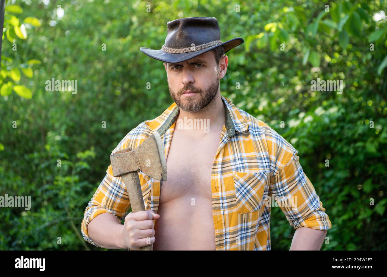 lumberjack with axe wearing unbuttoned checkered shirt. lumberjack with ...