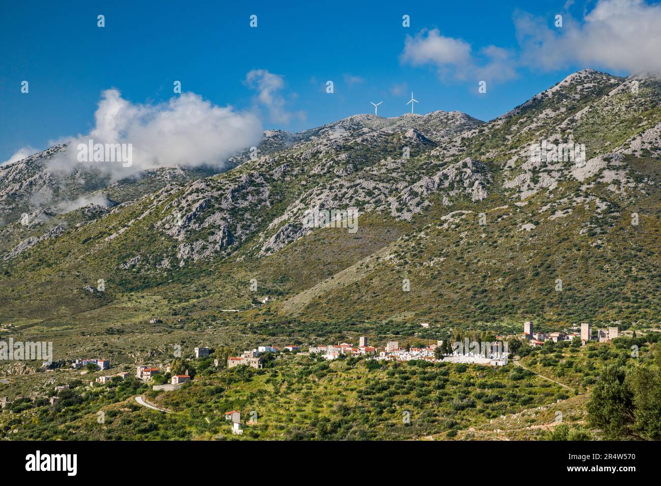 Tower houses in village of Flomochori, wind turbines at Mount Sangias ...