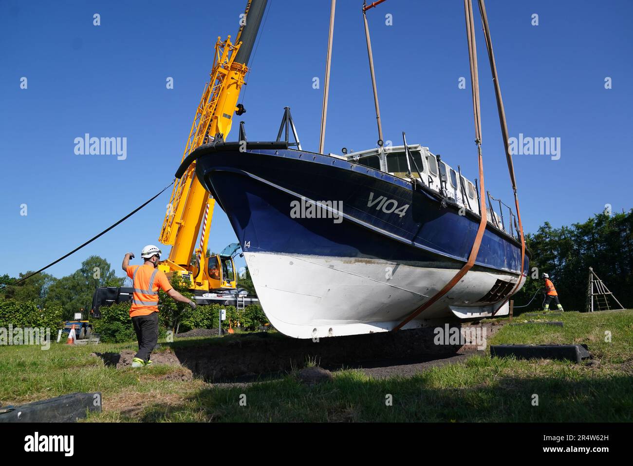 A former RNLI lifeboat as it is lowered into Martyn Steedman's camping ...