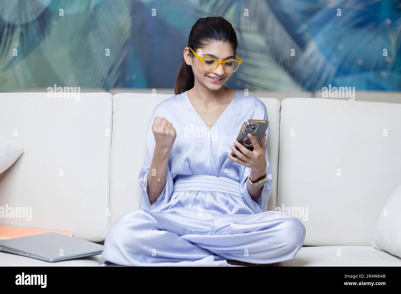 Excited cheerful gen Z female using mobile phone getting surprising ...