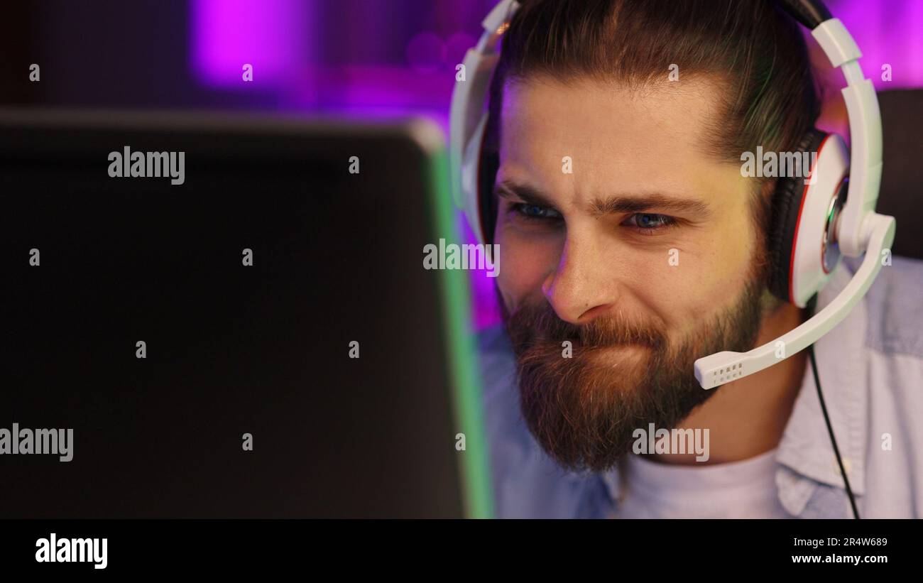 Close-up portrait of an esportsman. A professional gamer plays a ...