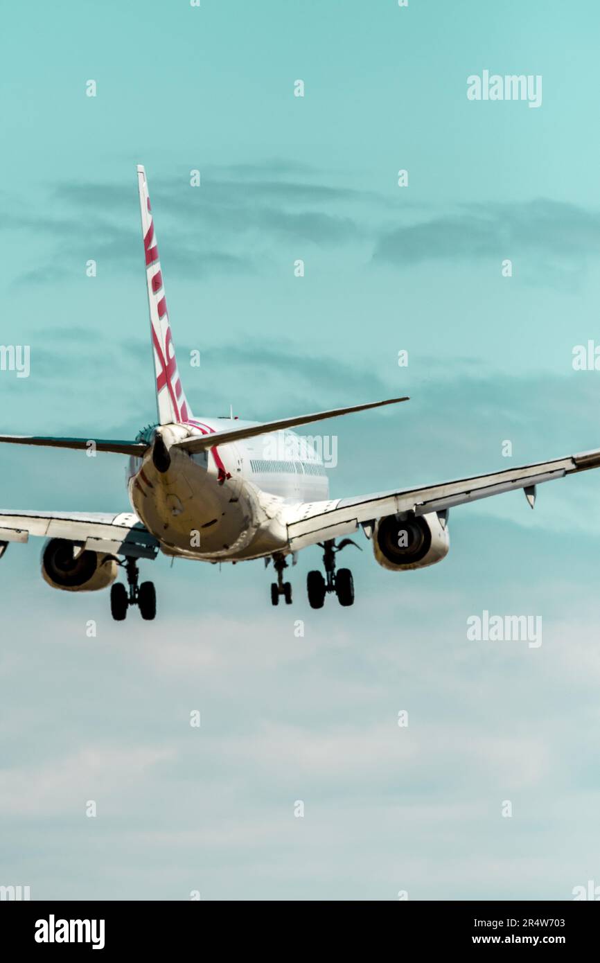 commercial planes flying near airport Stock Photo - Alamy