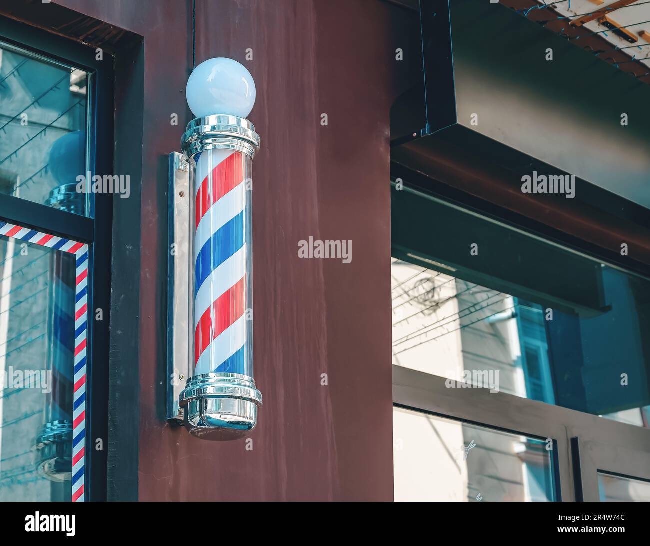 Signboard pole spinning on barbershop Stock Photo - Alamy