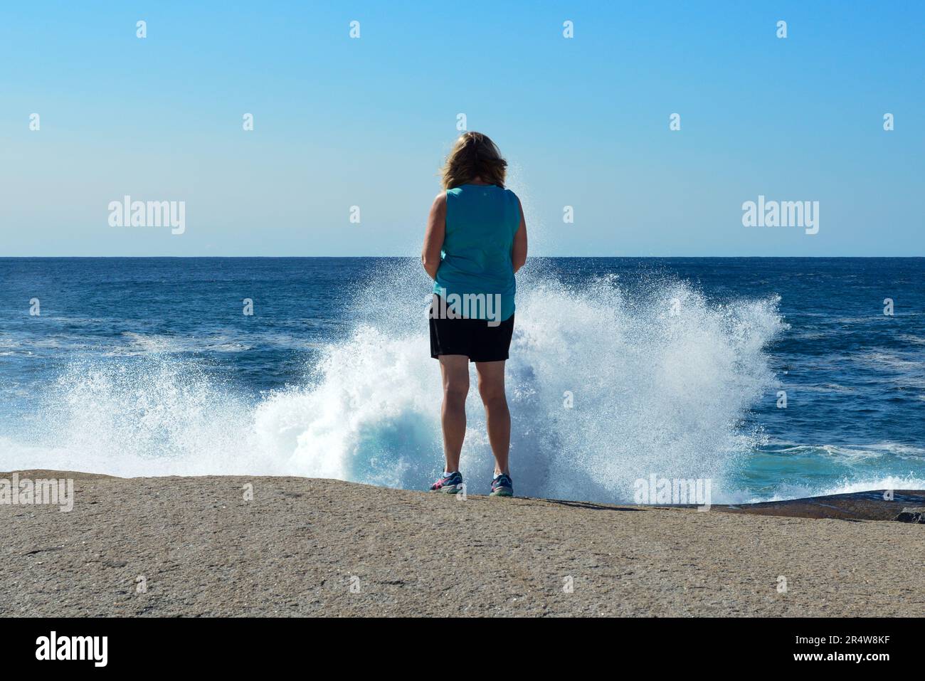 A stormy blue colored ocean with lots of crashing waves. There's a ...