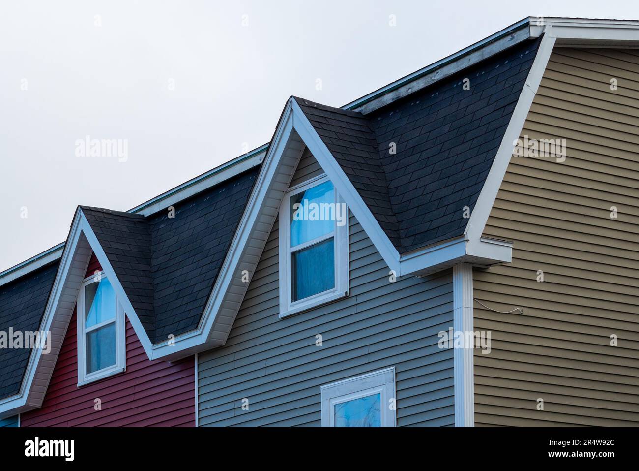 Multiple colorful row houses. The buildings have peaked roofs, glass ... Multiple colorful row houses. The buildings have peaked roofs, glass ...