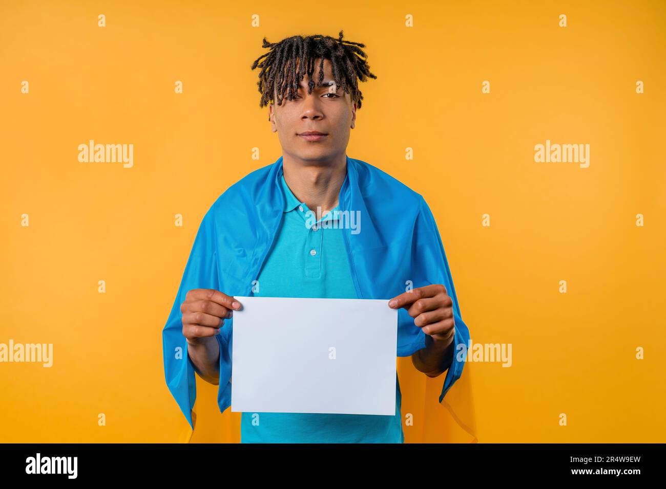 Handsome ukrainian man holding horizontal white a4 paper poster. Copy ...