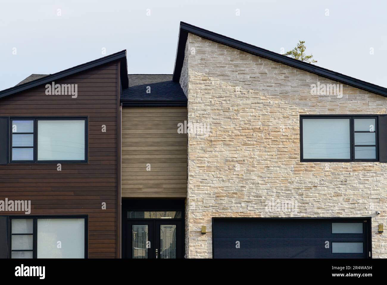 A street view of a modern suburban style house. There's a patio, the ...