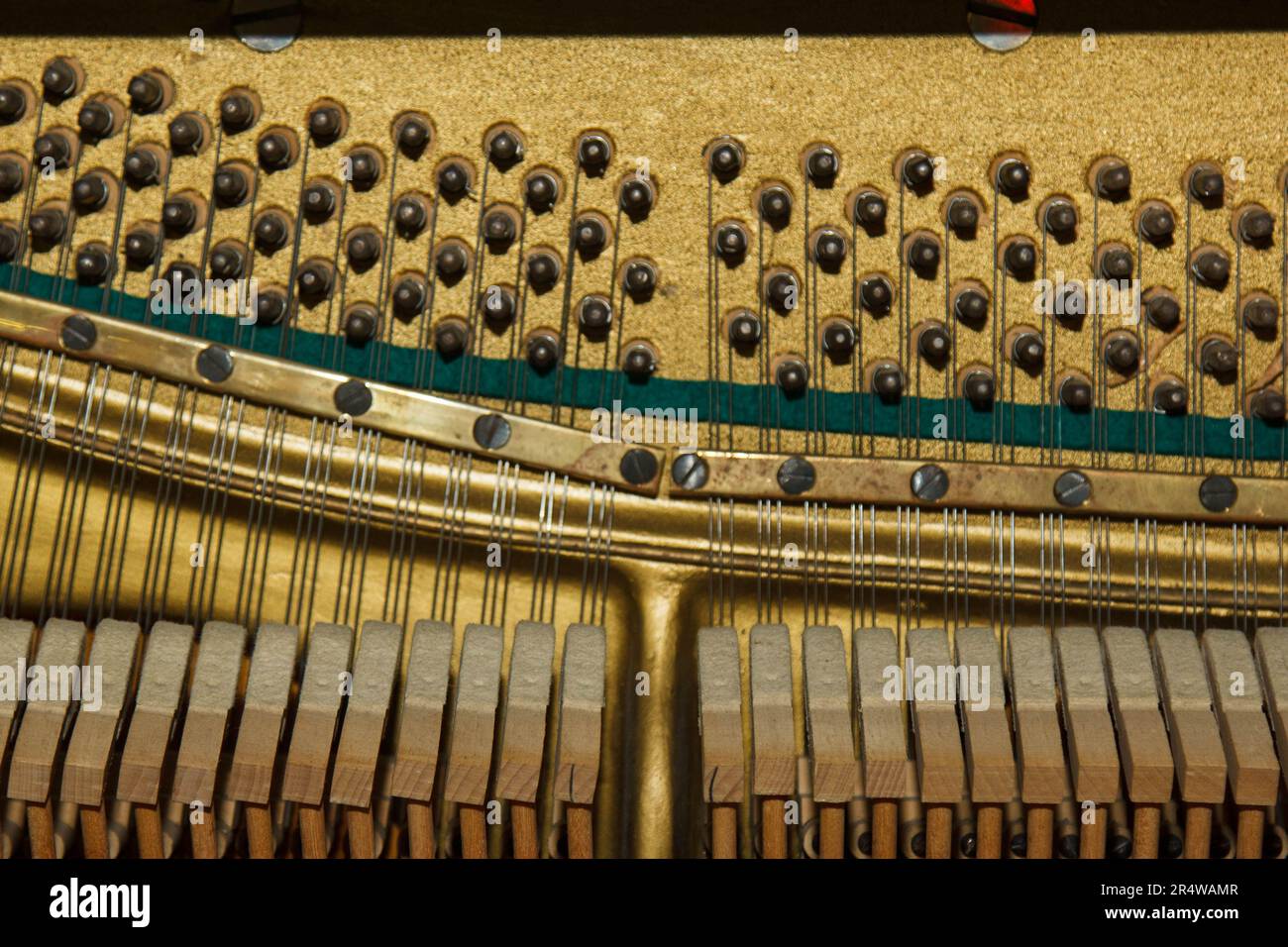 Internal parts of an old piano close-up - mechanics, strings. Selective ...