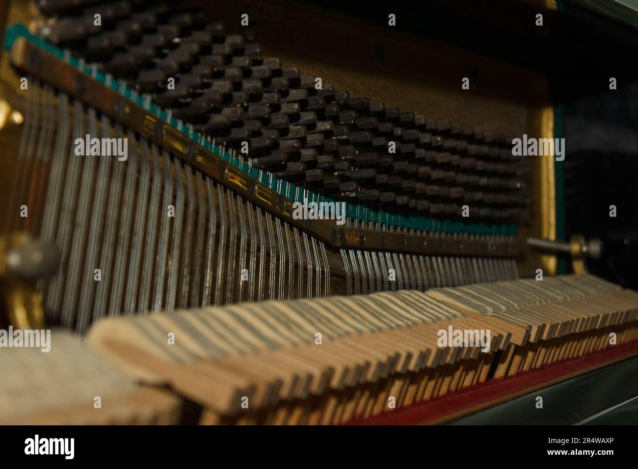 Internal parts of an old piano close-up - mechanics, strings. Selective ...