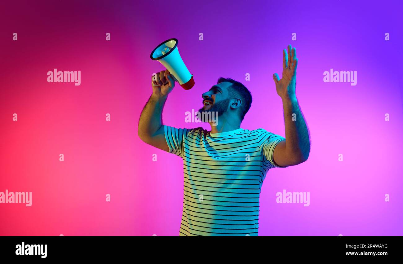 Portrait of excited, happy, smiling man in striped shirt shouting in ...