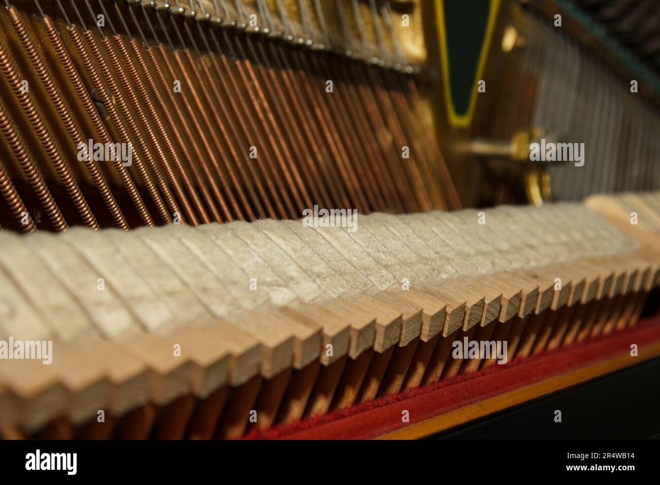 Internal parts of an old piano close-up - mechanics, strings. Selective ...