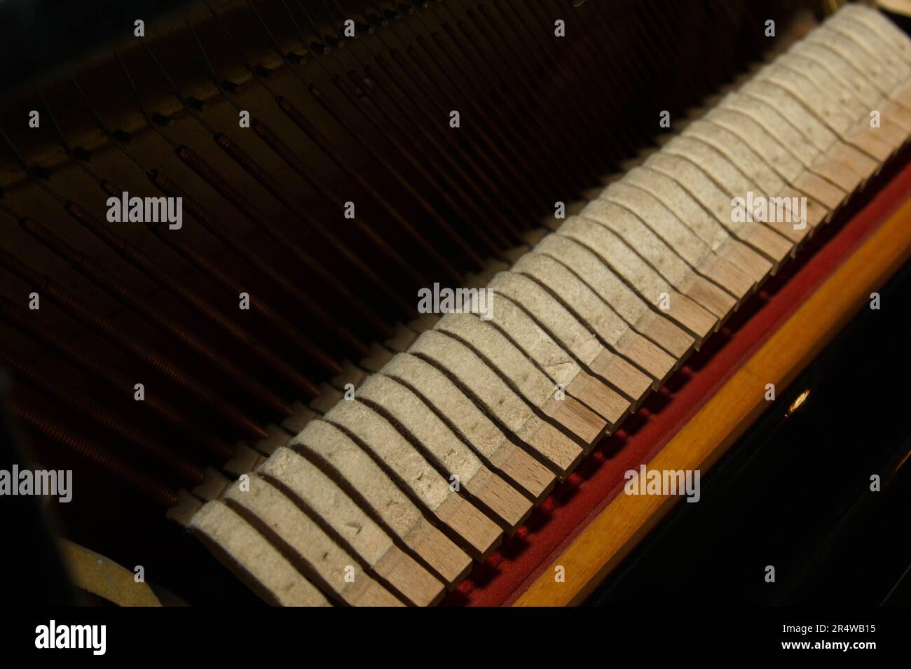 Internal parts of an old piano close-up - mechanics, strings. Selective ...