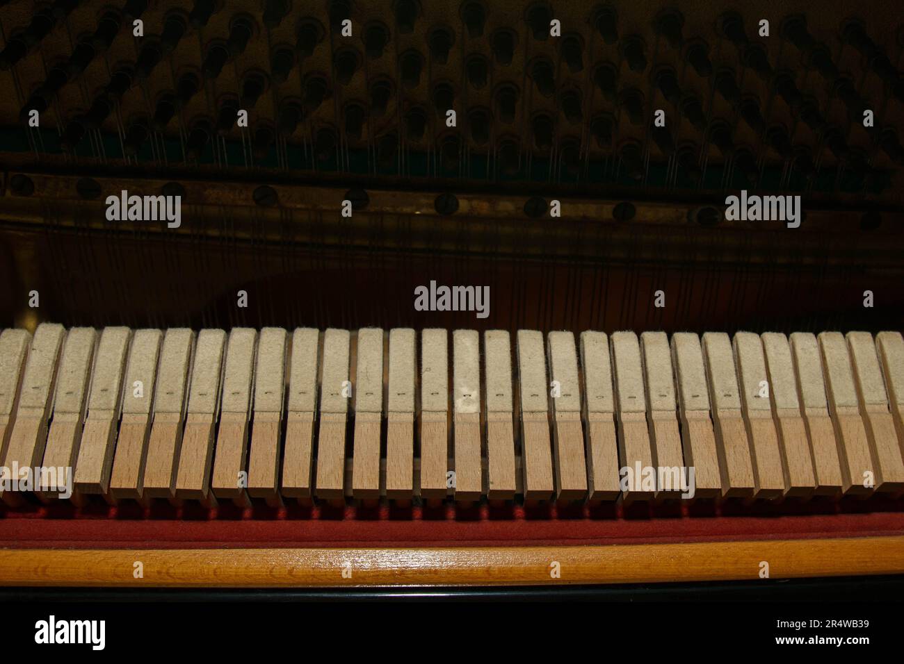 Internal parts of an old piano close-up - mechanics, strings. Selective ...
