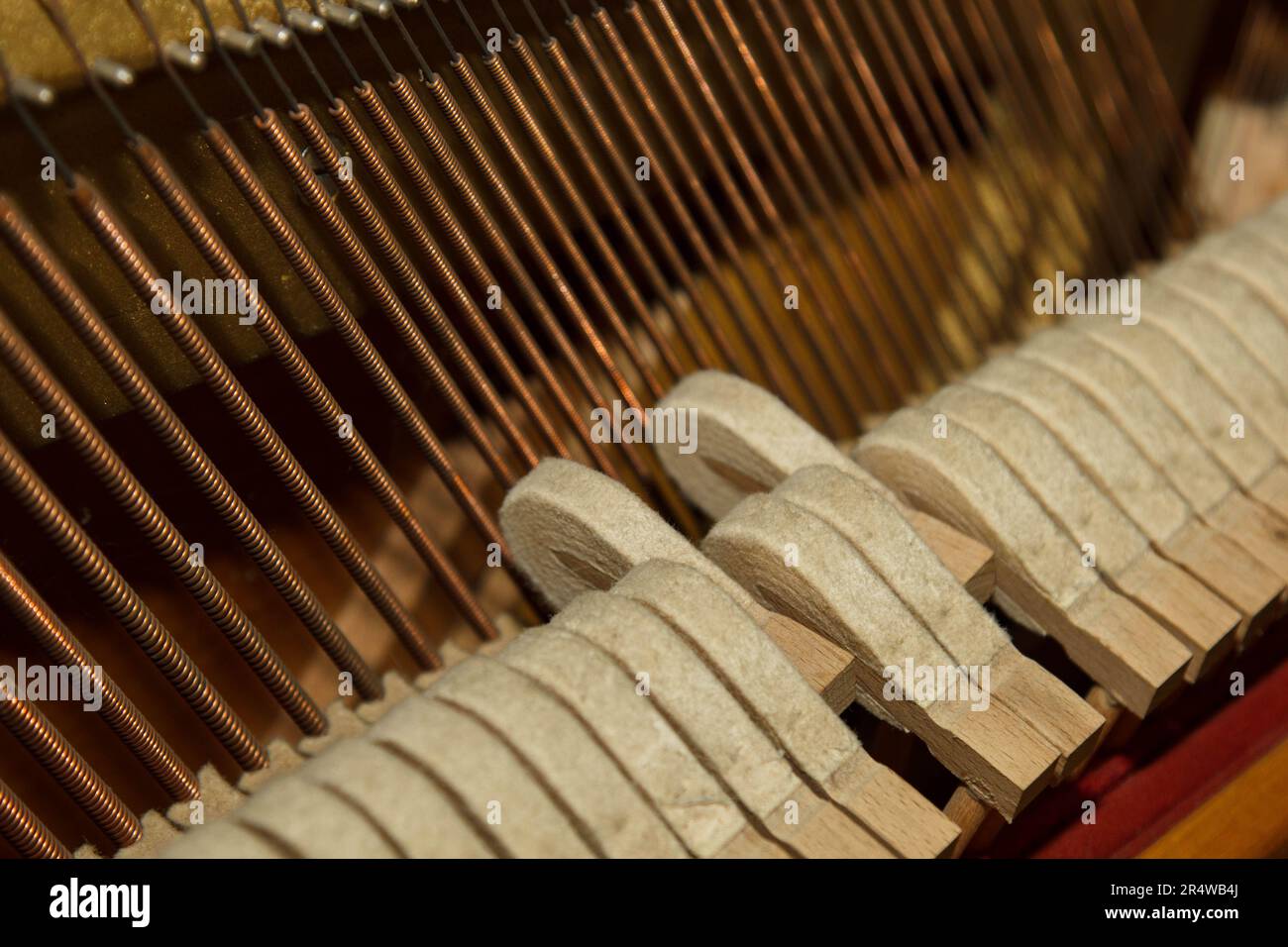 Internal parts of an old piano close-up - mechanics, strings. Selective ...