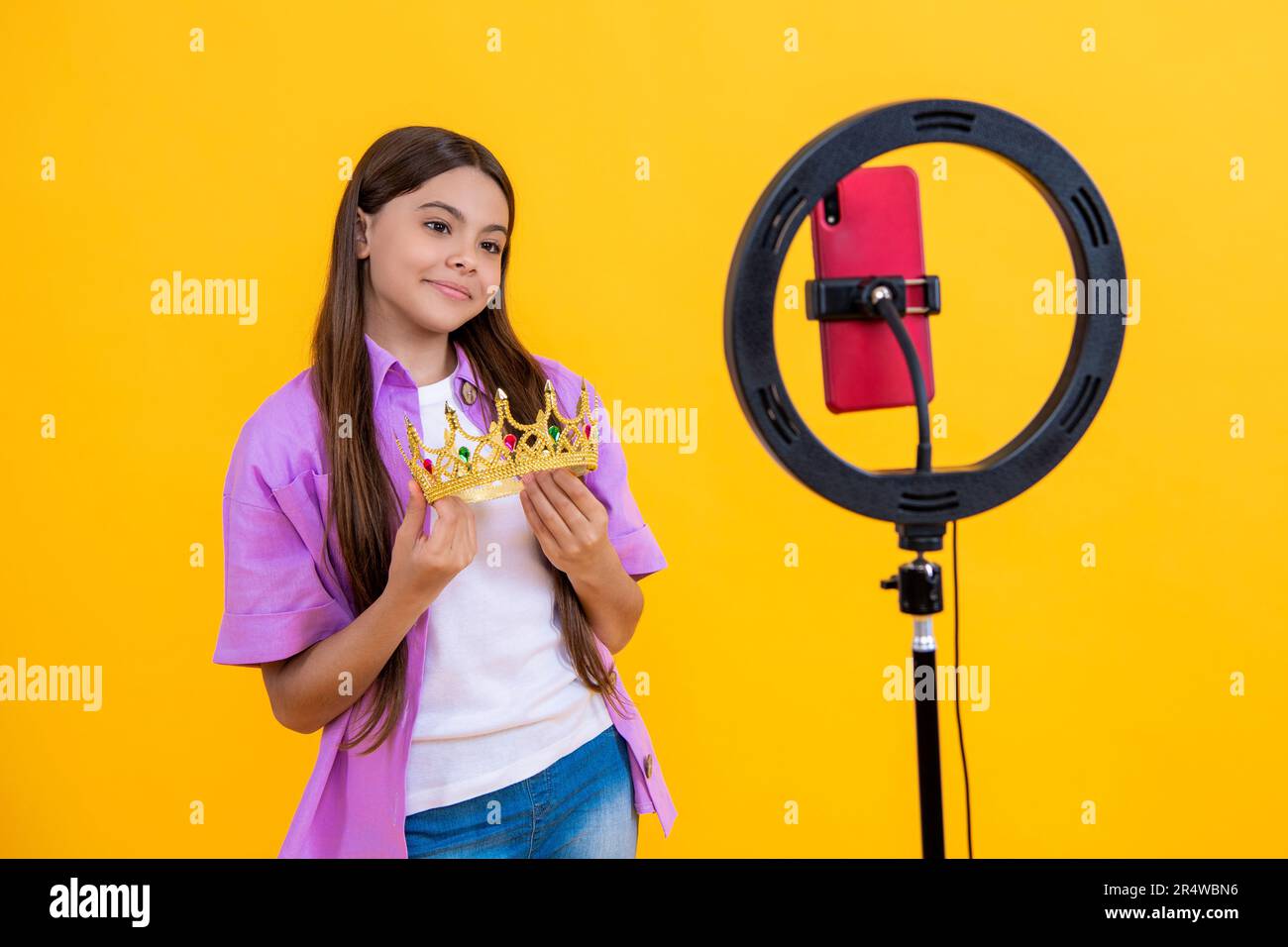 cheerful teen girl influencer with crown in studio. teen girl ...