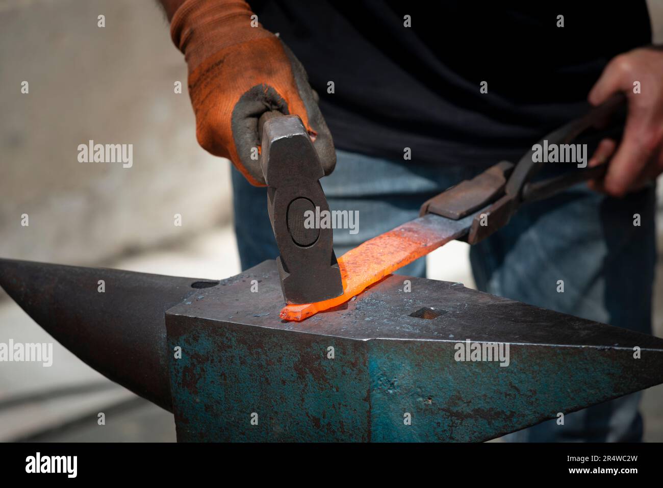 Blacksmith Forging a Red Hot Piece of Iron Stock Photo - Alamy