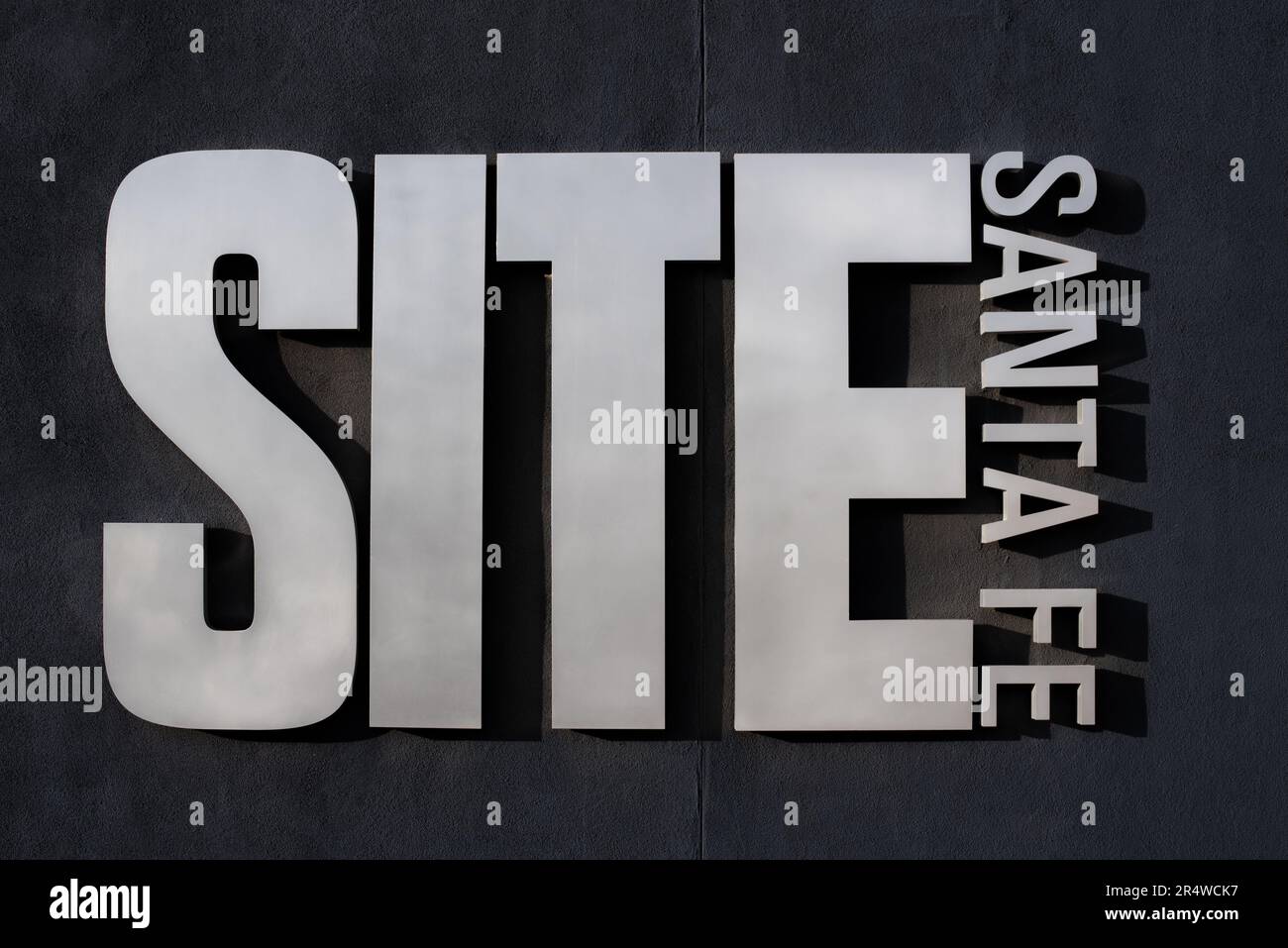 Bright metal letters spell out SITE Santa Fe on the wall of a ...
