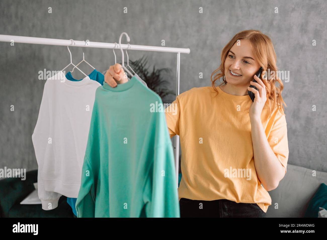 Image of pleased Caucasian young adult woman using cell phone, reading ...