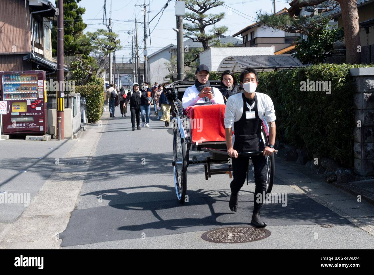 March 7, 2023, Kyoto, Japan: Tourists getting a rickshaw ride to ...