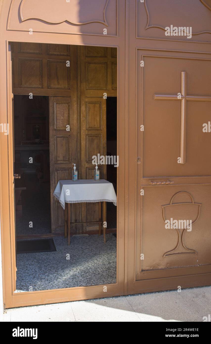 Parish church entrance with dispensers of hand sanitizer gel. Hygiene ...