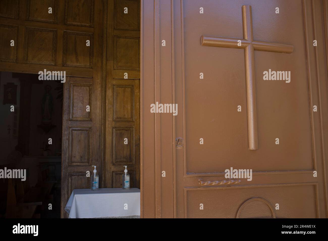 Parish church entrance with dispensers of hand sanitizer gel. Hygiene ...