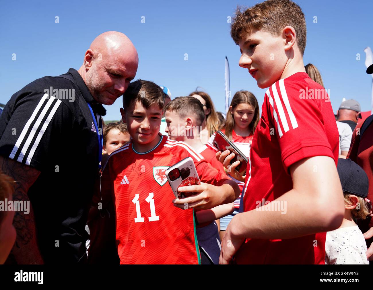 Wales manager Rob Page poses for a photo with a fan following the Wales ...
