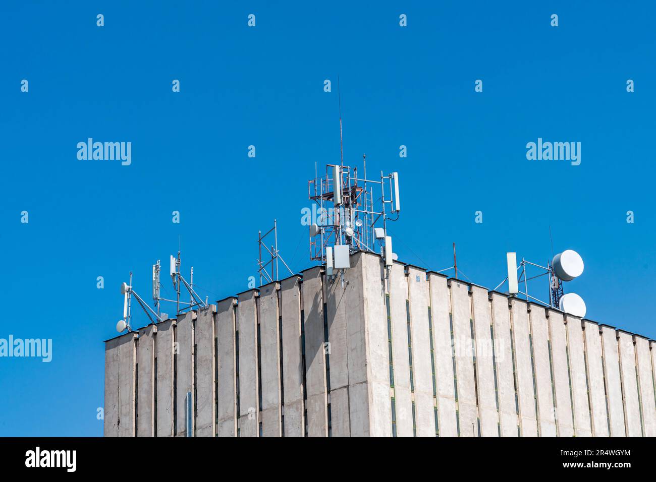 Satellite and telecommunications antennas on the roof of a concrete ...