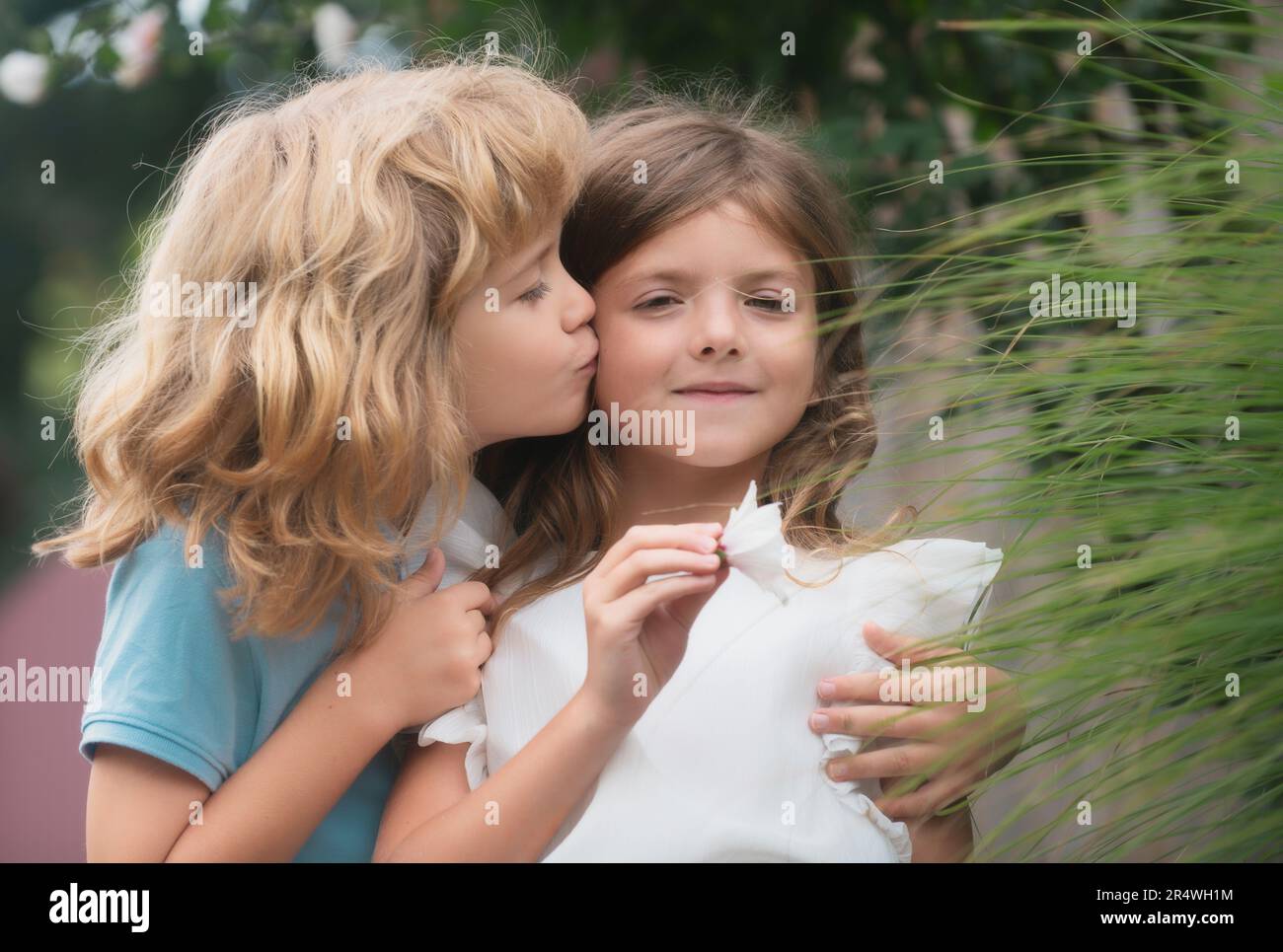 Hugging and kissing kids couple. Little lovely children outdoor ...
