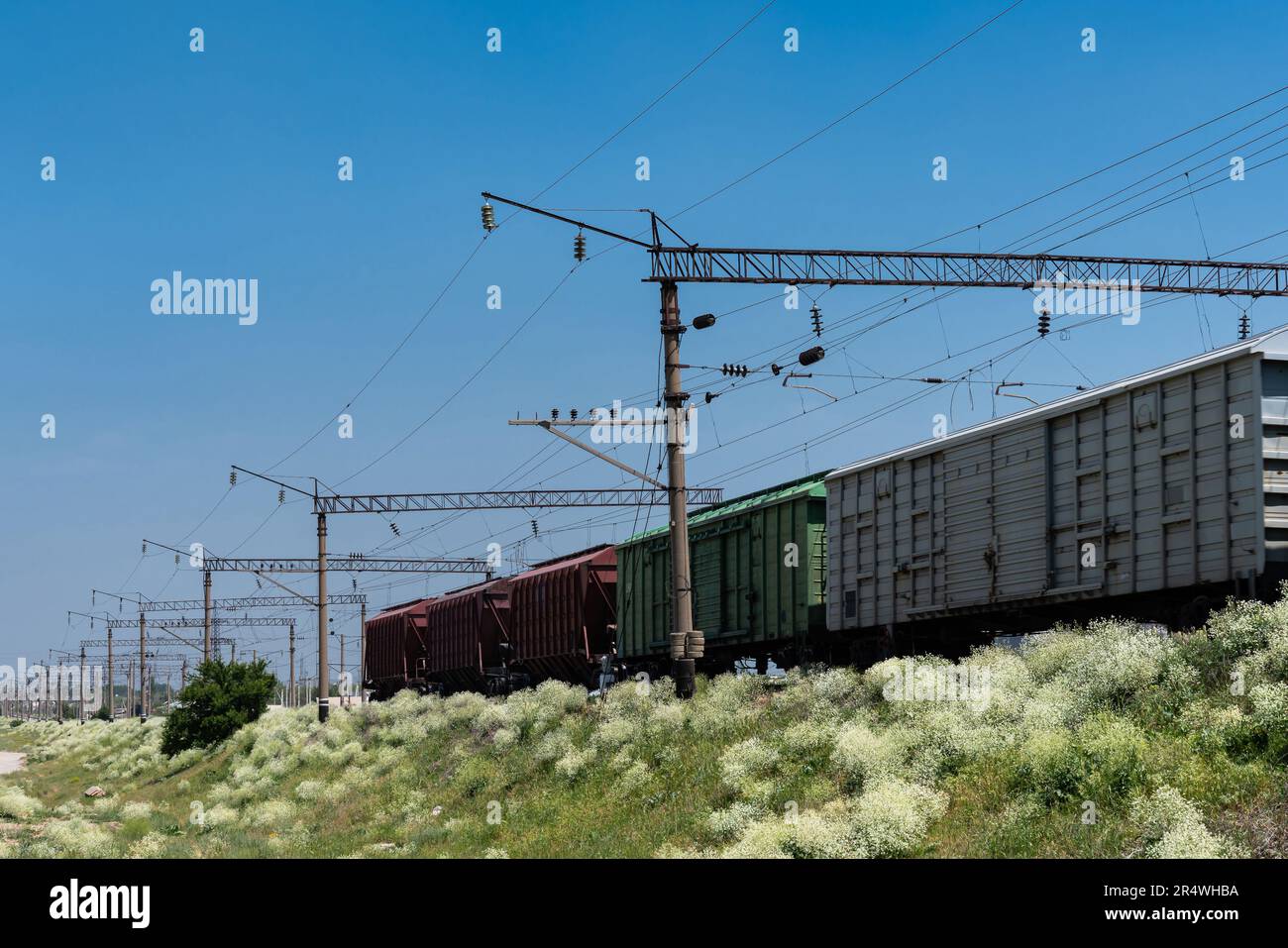 View of the railroad track with rolling cars falling. Clear blue sky ...