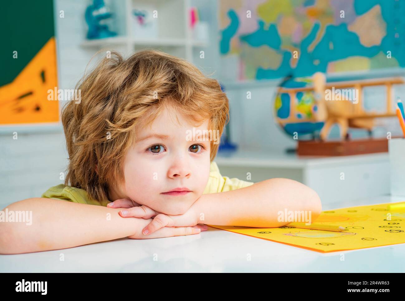 Little children at school lesson. Kid is learning in. Portrait of Pupil ...