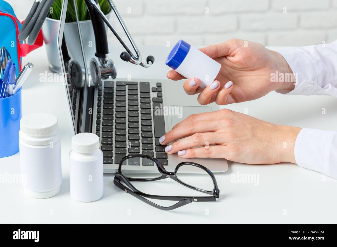 Female doctor is typing in laptop computer Stock Photo - Alamy